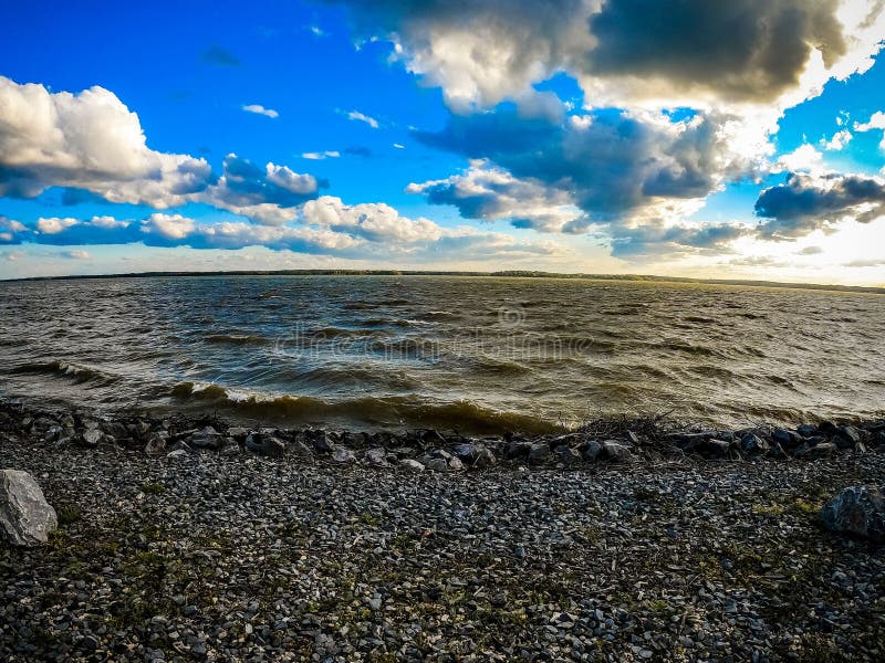 Beach Shoreline, with a Vast Stretch of Ocean Dotted with Fluffy White ...
