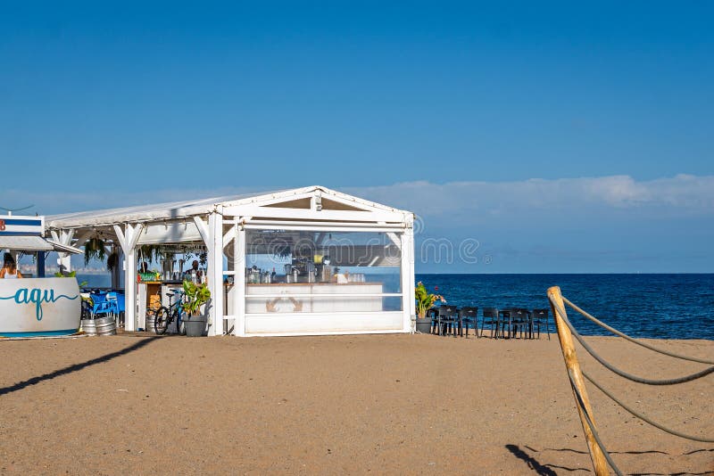 A Beach Side Bar and Restaurant with White Wooden Structures, Seating ...