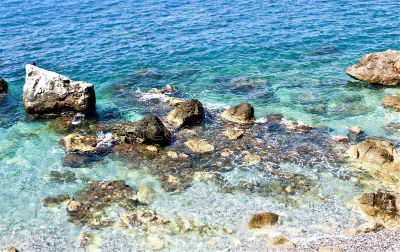 Beach of Stones Cove Formed by Rocks Stock Photo - Image of lightblue ...