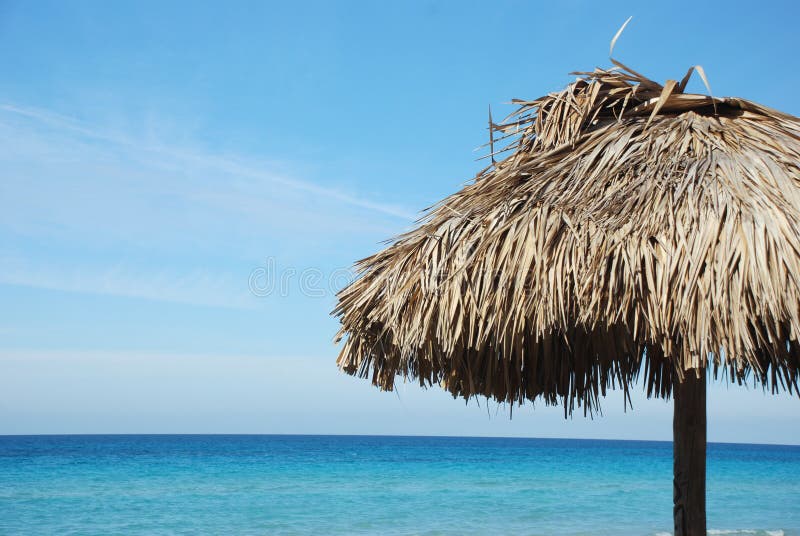 Straw umbrella ocean stock image. Image of swaying, breeze - 97803145