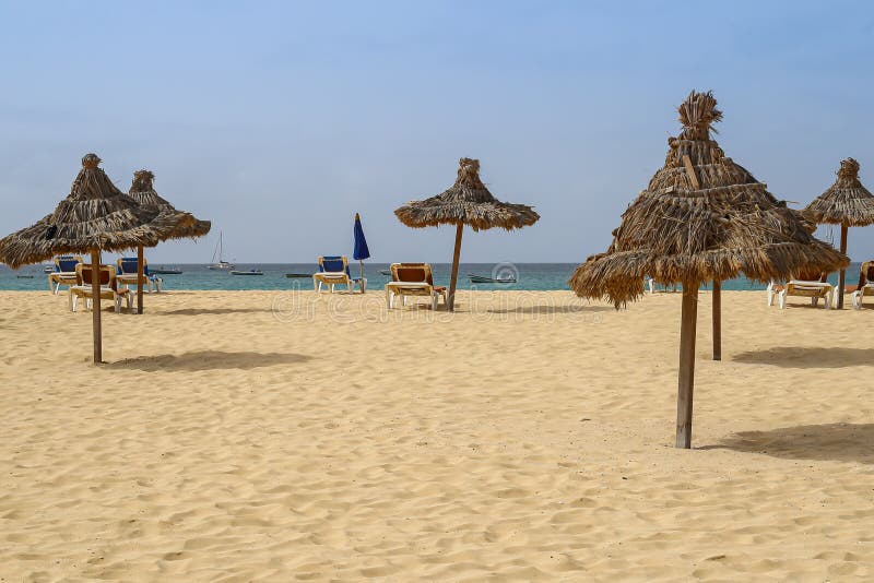 Beach with Straw Umbrellas and Beds Stock Image - Image of straw, beds ...