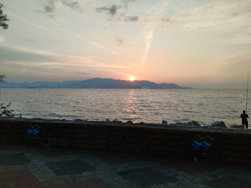 From the the Beach the Sun Set Behind the Island Stock Photo - Image of ...