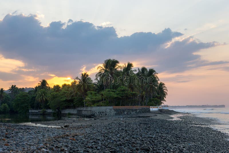 Beach at Sunrise with Dark Rocks and Nice Sunrays. Stock Photo - Image ...