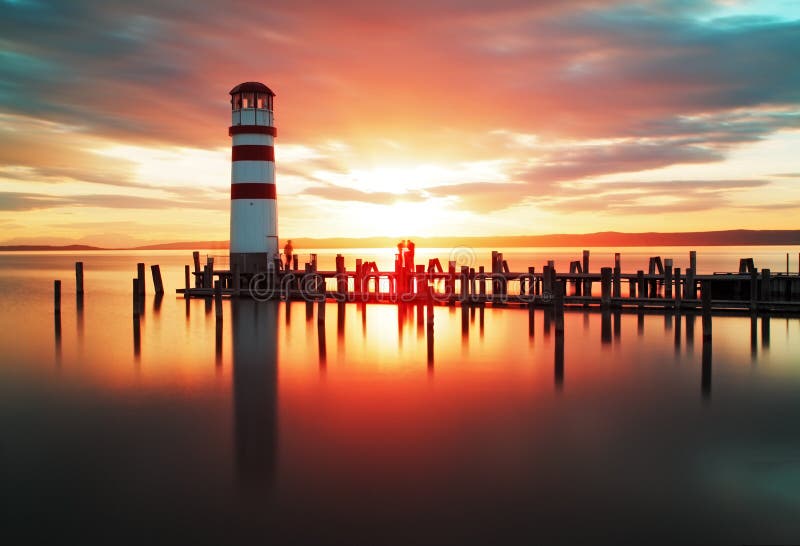 Beach Sunrise with Lighthouse Stock Photo - Image of clouds, coast ...