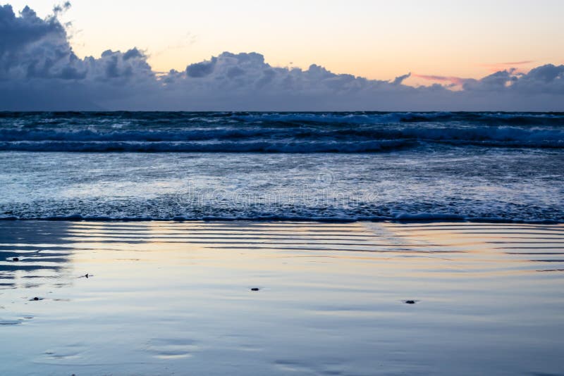 The Beach at the Sunset with the Approaching Waves - Image Stock Image ...