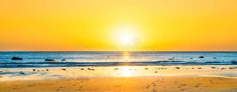 Beach sunset with blue sea stock photo. Image of golden - 252874924