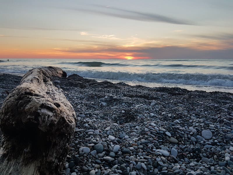 Beach at sunset stock image. Image of lake, huron, beach - 99790695