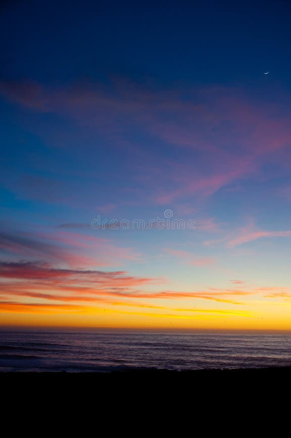 Beach at sunset with moon stock image. Image of cloudy - 23768717
