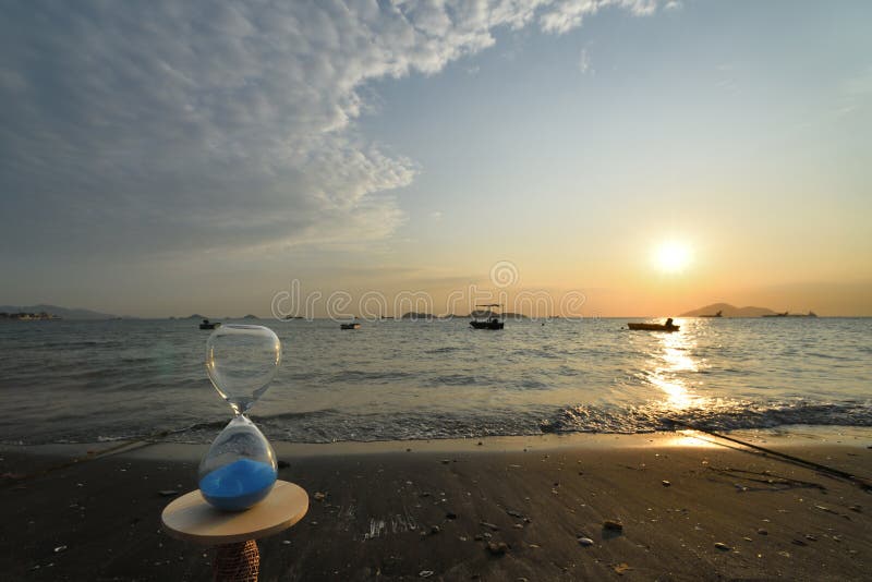 Beach sunset sand timer stock image. Image of layer - 215697385