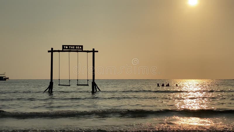 Beach Swing and Watching Ocean Waves. Carefree Summer Moment at Ocean ...