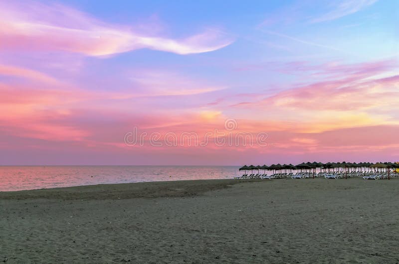 Beach in Torremolinos, Spain. Stock Photo - Image of umbrella, sunset ...