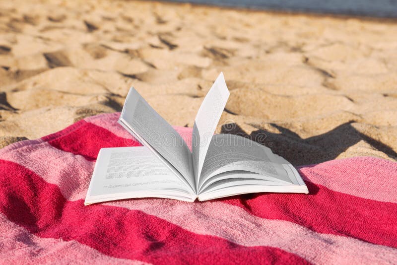 Beach Towel and Open Book on Sand Near Sea Stock Image - Image of sunny ...