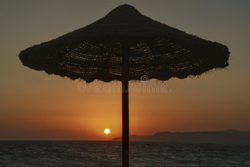 Beach Umbrella at Sunset with Setting Sun Stock Image - Image of costa ...