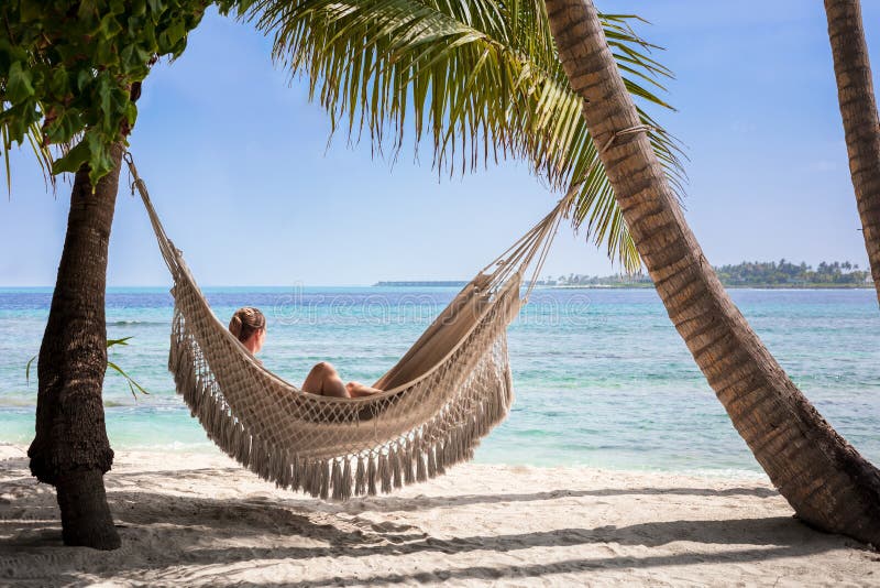 Beach Vacation Holidays With Woman Relaxing In Hammock Between Coconut