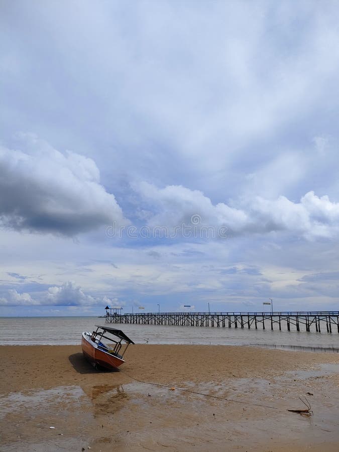 Beach View with Beautiful Sky, Bridge, Sand and Dinghy Stock Photo ...
