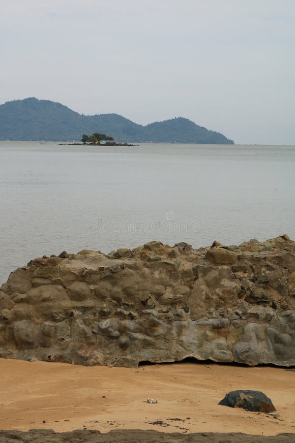 Beach View with Island and Stone Wall in Front of it Stock Photo ...