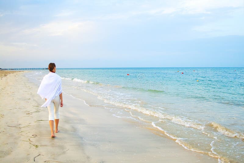Beach walk along a shore stock photo. Image of blue, adult - 7046418