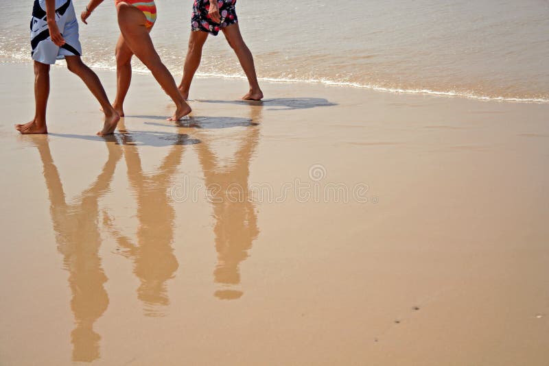 Beach walkers stock image. Image of bathers, barefoot - 1169423