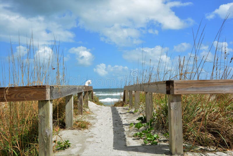 Beach Walkway Under Clouds stock image. Image of high - 78890111