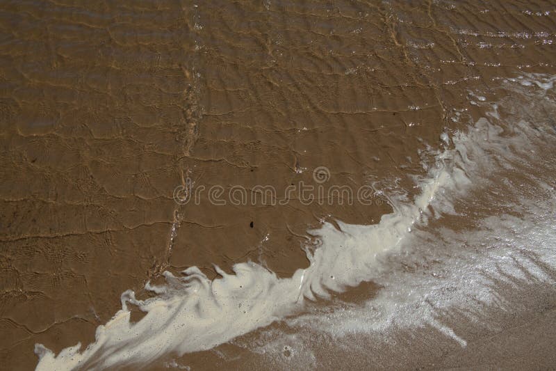 A Beach with a Wave of Foam on the Sand Stock Photo - Image of ocean ...