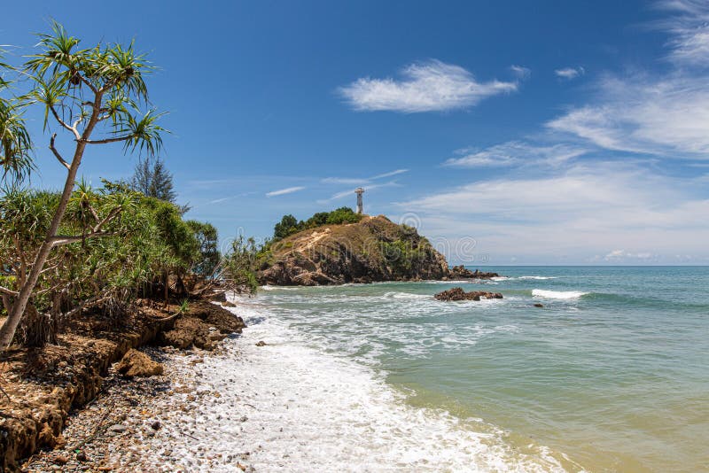 Beach Waves and Trees with a Lighthouse in the Background. Stock Photo ...