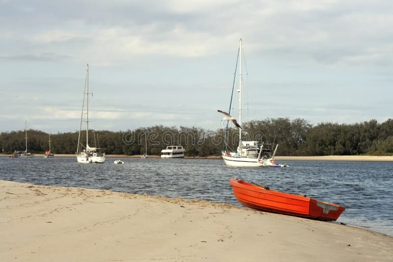 A beached red Dinghy stock image. Image of beach, gold - 53309783