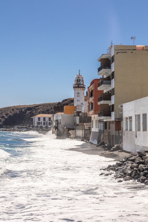 Beachfront Town with a Rocky Cliffside, Featuring Multiple Buildings ...