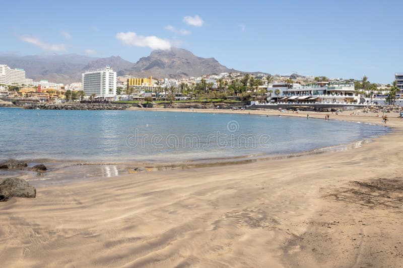 Beachfront Town with a Rocky Cliffside, Featuring Multiple Buildings ...