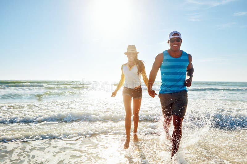 Beachy Fun. a Happy Young Couple Taking a Walk on the Beach. Stock ...