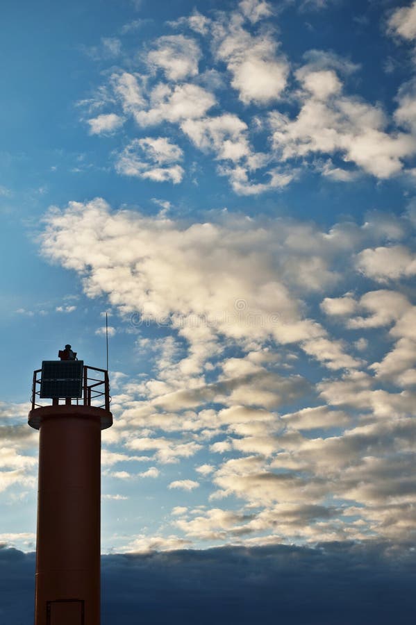 Beacon on Cloudy Blue Sky Background. Sunset on Baltic Sea Stock Photo ...