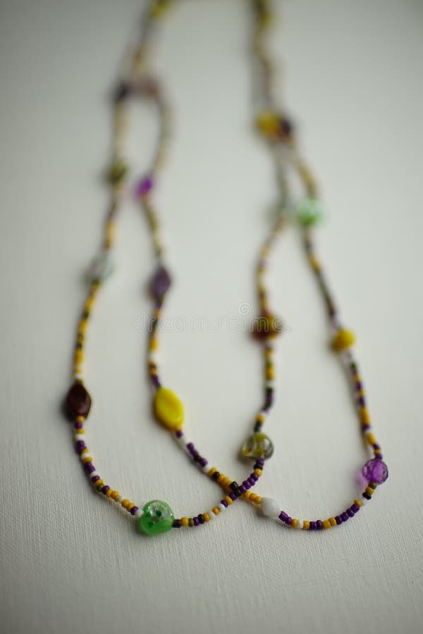 Beads of Beads and Different Stones on a White Texture Table Stock ...