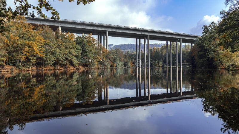 Beam Bridge Over a River Running through an Autumn Forest Stock Photo ...