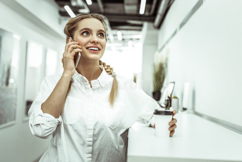Beaming Light-haired Girl Having Call on Mobile Phone while Spending ...