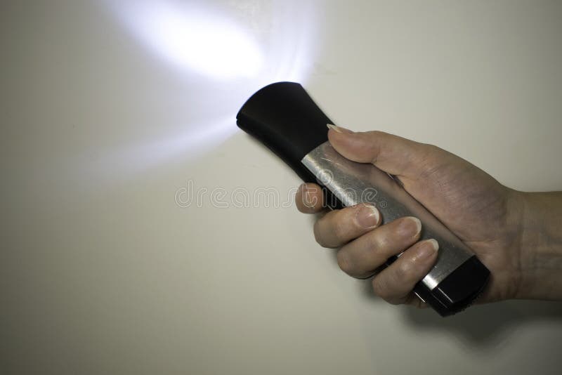 Hand Holding a Shining Flashlight Stock Photo - Image of night ...