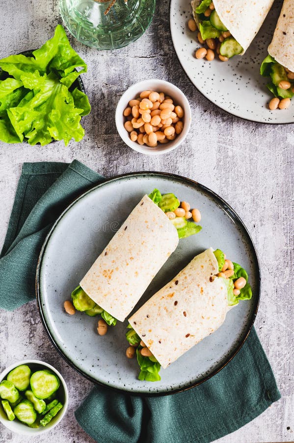 Beans, Cucumber and Leaves Wrapped in Tortilla Roll on Plate on Table ...