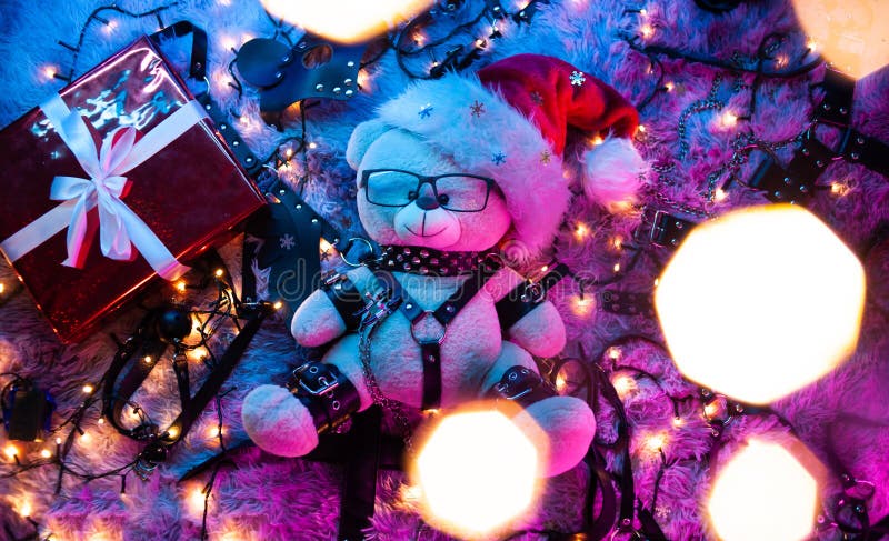 A Bear In A Santa Claus Hat Is A Christmas T For Bdsm Games From A Sex Shop In Neon Light For