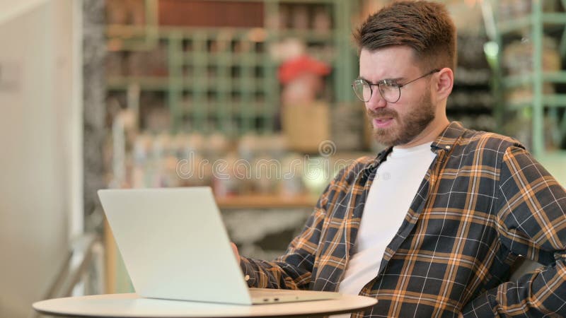 Young Man with Back Pain Using Laptop in Cafe Stock Footage - Video of ...