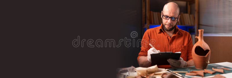 Bearded Archaeologist in Glasses Working in the Office Late at Night ...