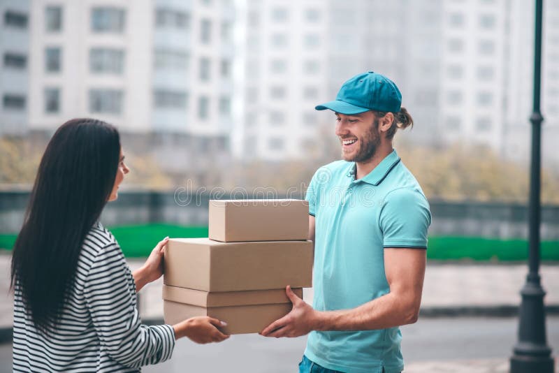 Bearded Delivery Man Smiling while Talking To Customer Stock Photo ...