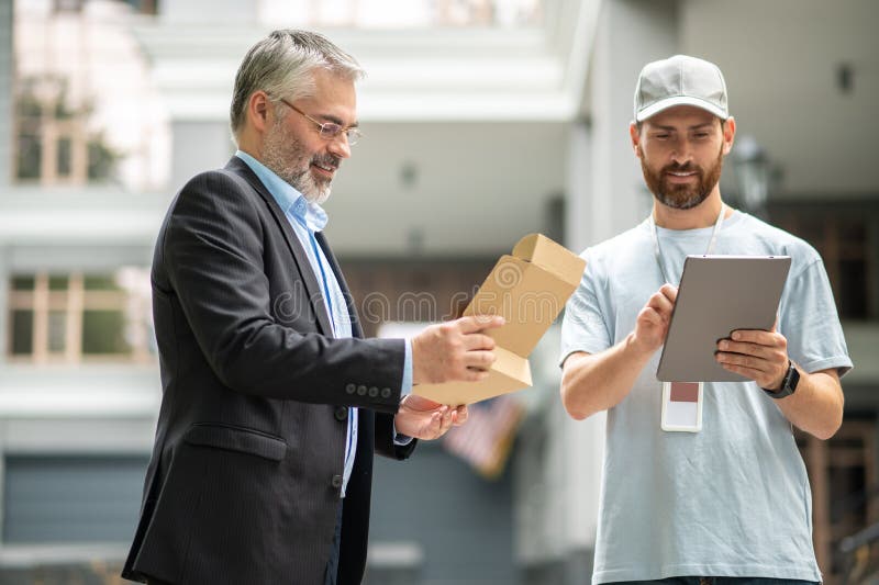 Bearded Elegant Businessman Taking the Box from a Courrier Stock Photo ...