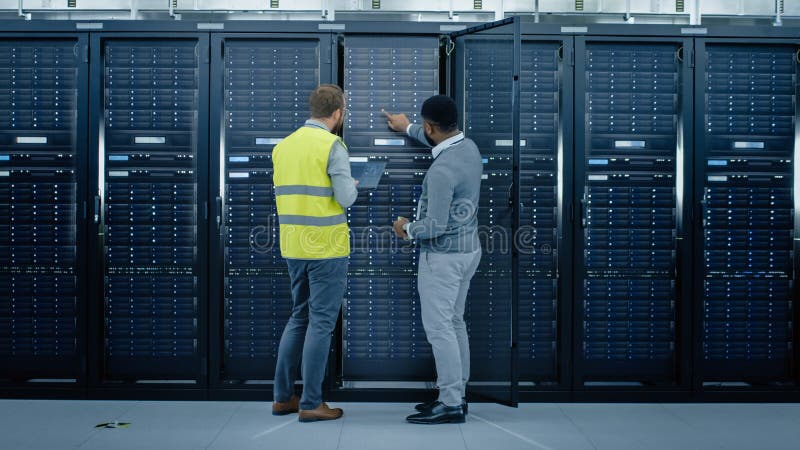 Bearded it Engineer in Glasses and High Visibility Vest with a Laptop ...