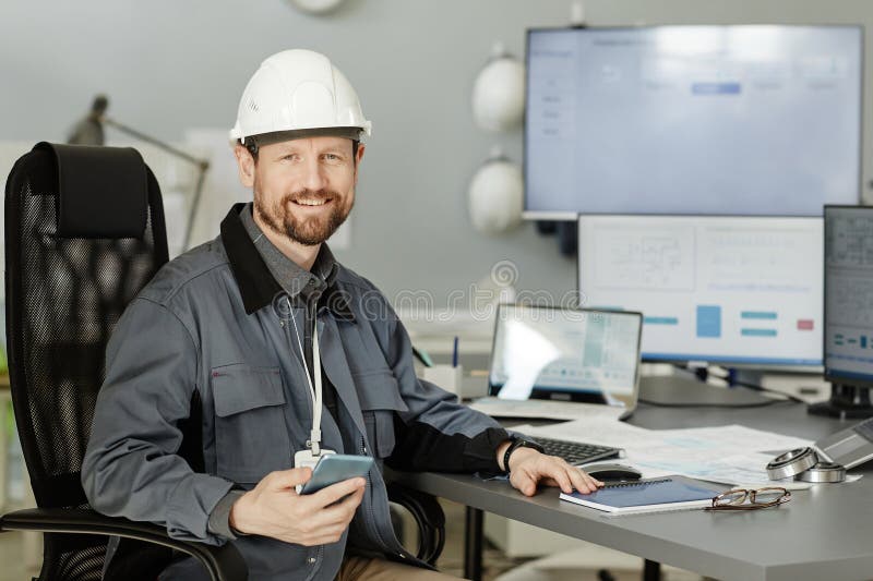 Bearded Engineer Wearing Hardhat at Workplace in Office and Smiling ...