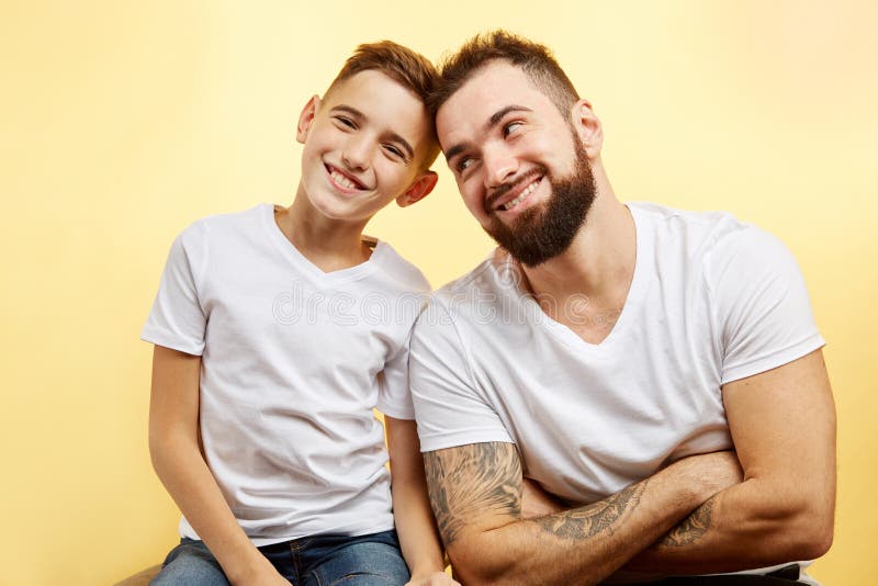 Bearded Father and Little Son Smile for Camera on Yellow Background ...
