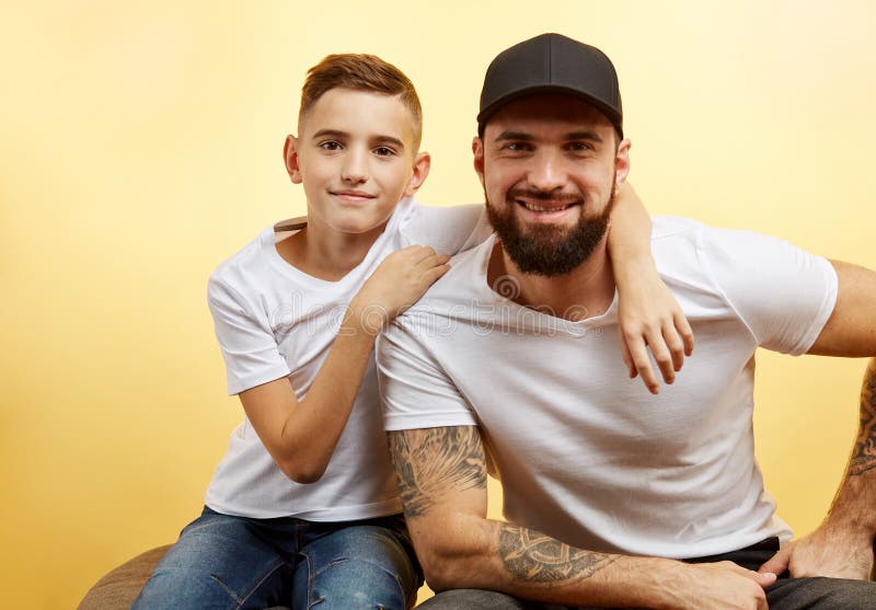 Bearded Father and Little Son Smile for Camera on Yellow Background ...