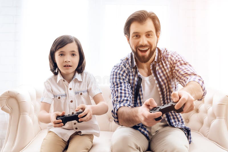 Bearded Father with Son Plays Computer Game Using Game Controllers ...