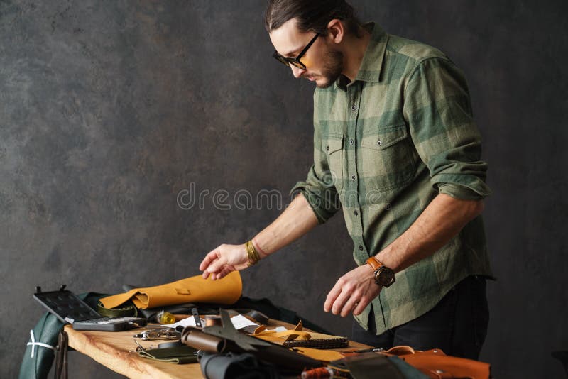 Bearded Focused Craftsman Working with Leather while Standing at Table ...