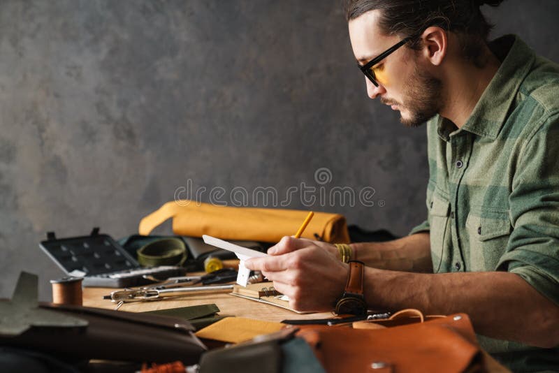 Bearded Focused Craftsman Writing Down Notes while Sitting at Table ...