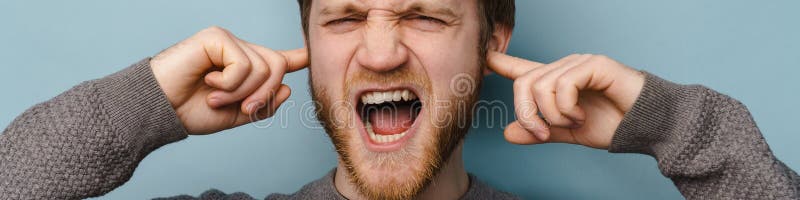 Bearded Ginger Man Screaming while Plugging His Ears Stock Image ...