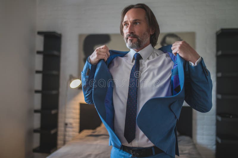 Bearded Good-looking Man Putting on His Jacket Stock Image - Image of apartment, home: 257419129