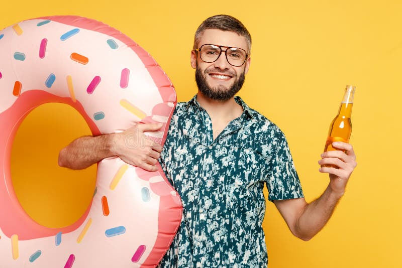 Bearded Guy In Glasses With Donut Swim Ring And Beer On Yellow Stock